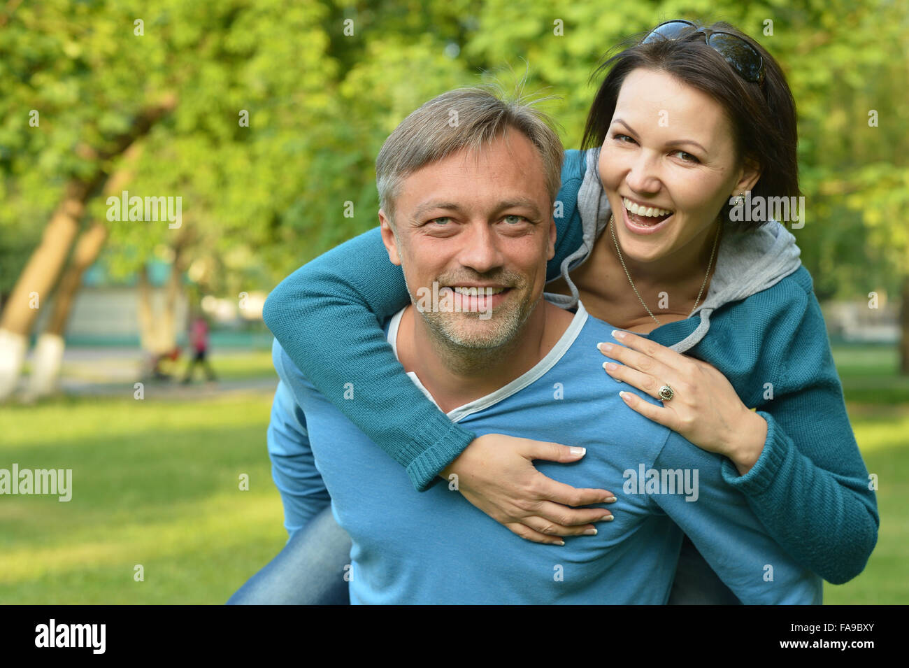 Happy family having nice time in summer park Stock Photo - Alamy