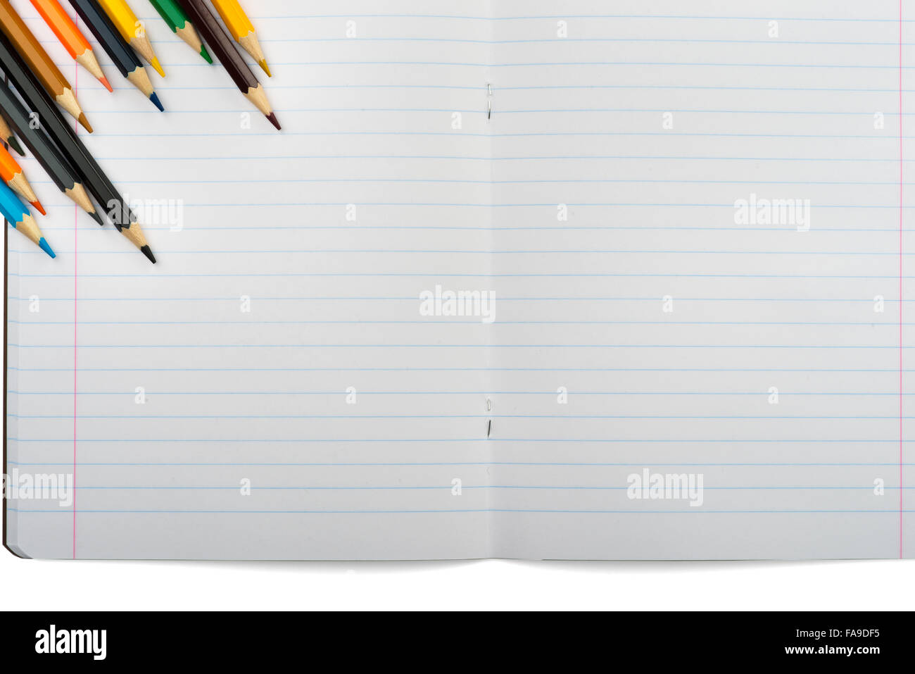 Open notebook with set of crayons Stock Photo - Alamy