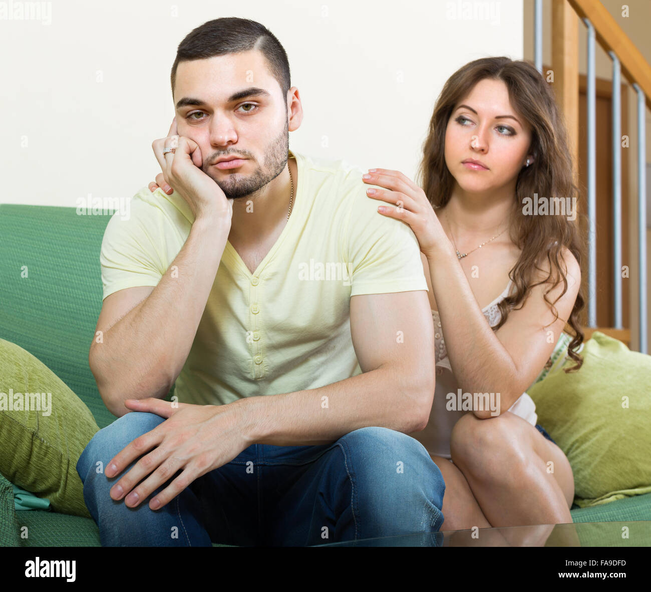Young wife tries reconcile with husband at home after quarrel Stock ...
