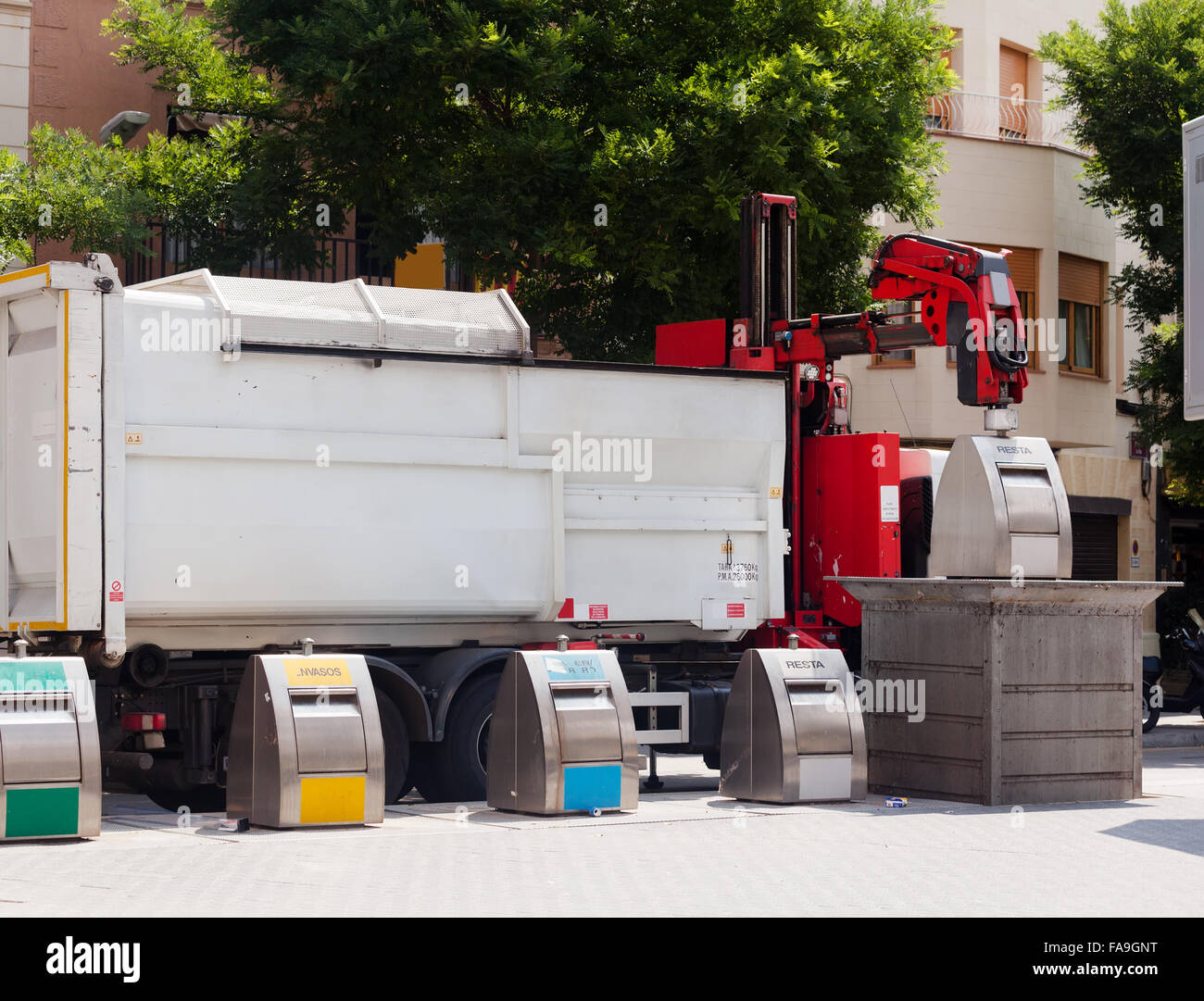 Recycling truck picking up bin at city street. Spain Stock Photo - Alamy