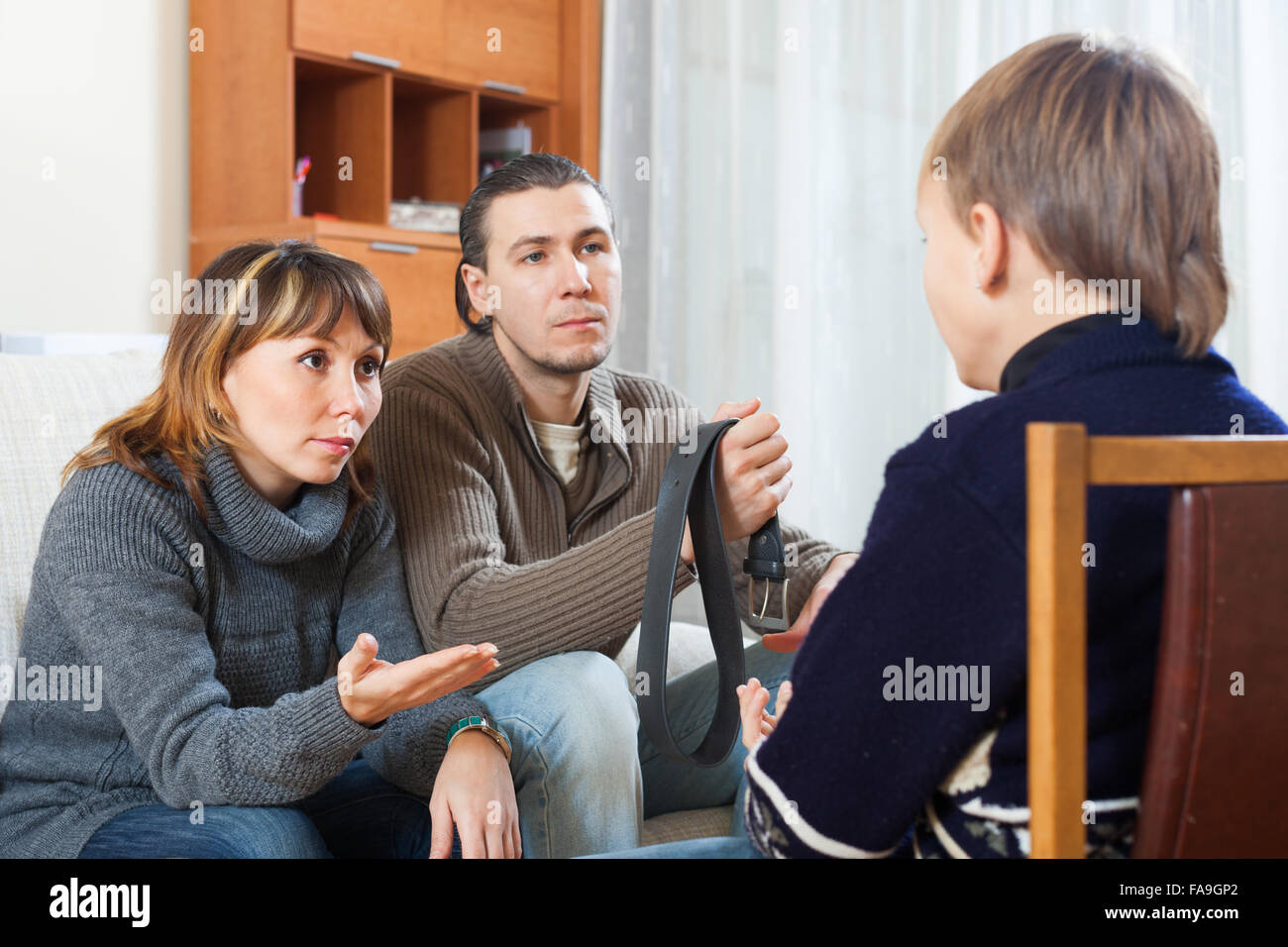 Parents scolding teenage son in home Stock Photo - Alamy