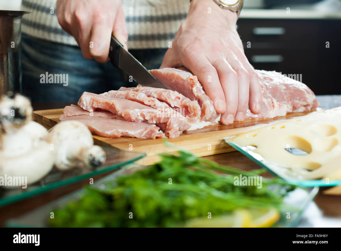 Steps of cooking french-style meat. Hands cutting raw meat Stock Photo ...