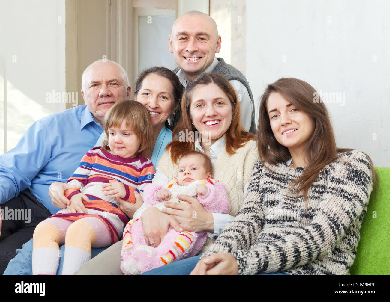 Portrait of joyful grandparents with children and grandchildren in home ...