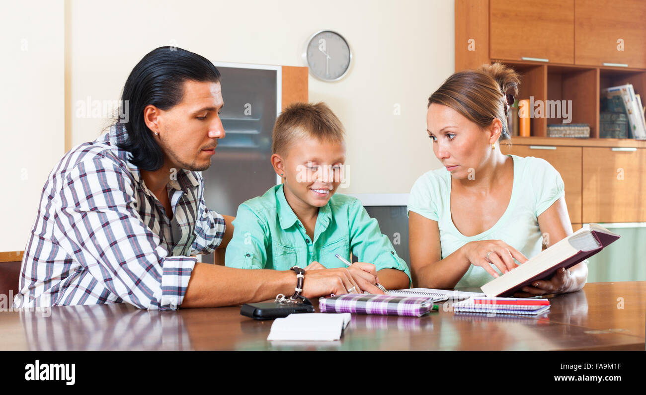 Happy family together doing homework in home Stock Photo - Alamy