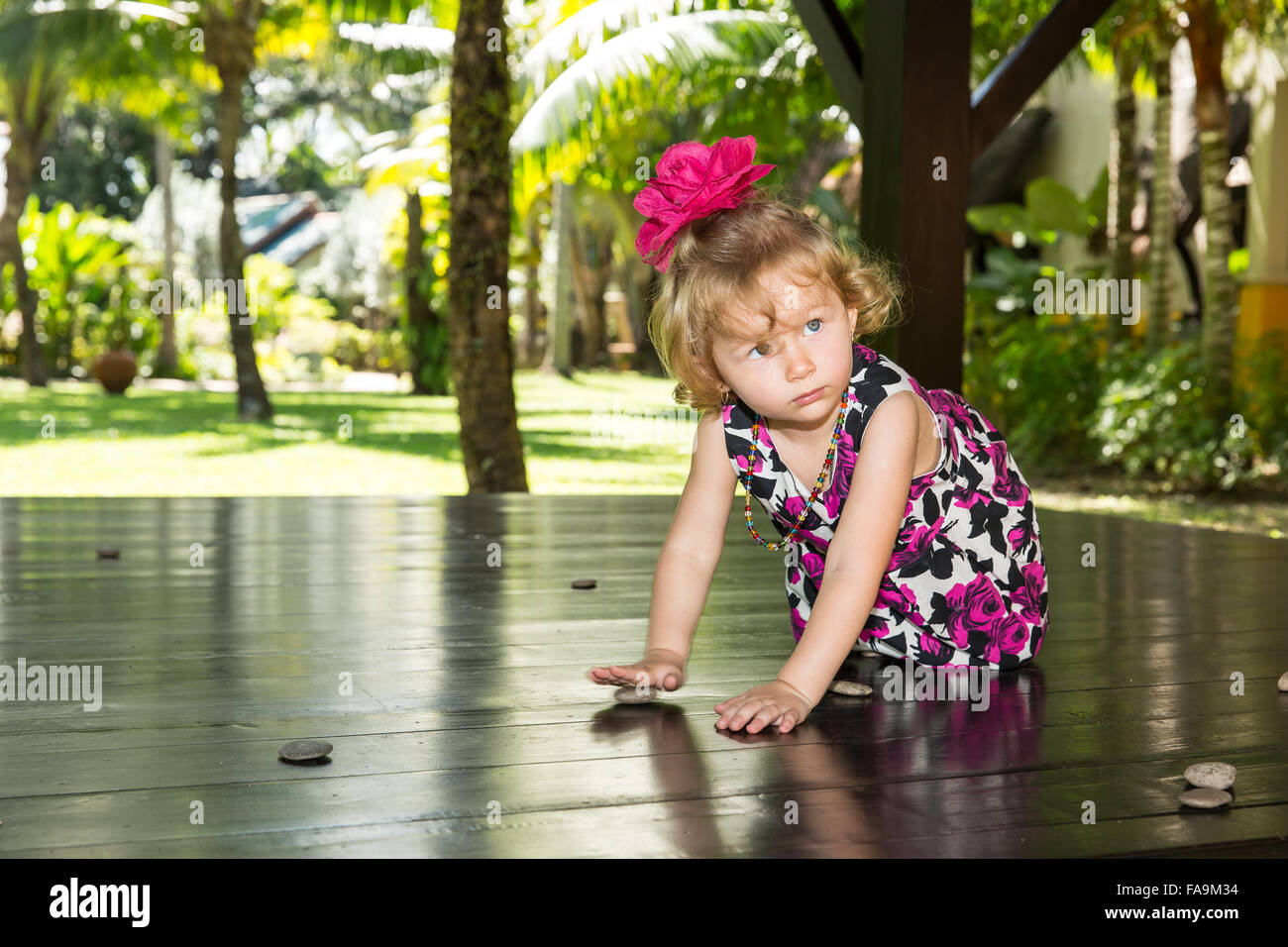Adorable little child girl. Summer green nature background. Use it for ...