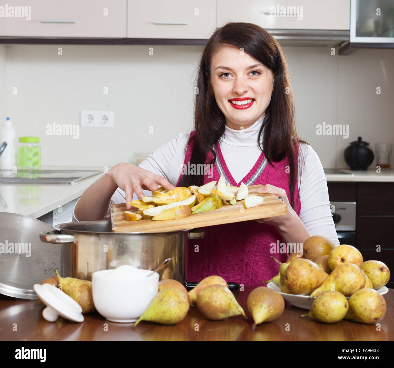 Brunette woman cooking pear jam in home kitchen Stock Photo - Alamy