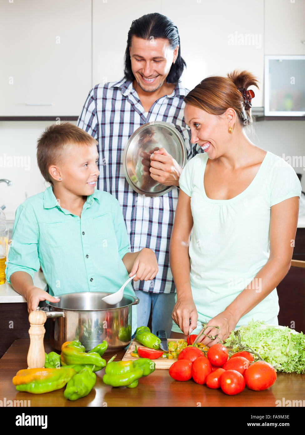 Parents and teenager cooking together at home kitchen Stock Photo - Alamy