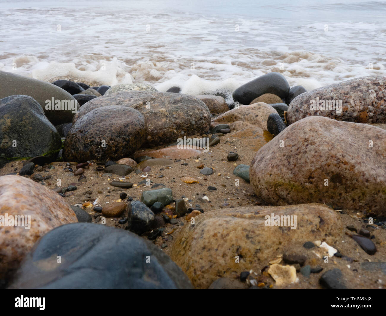 Pebbles on a beach at Sandscale Haws Nature Reserve, Lake District, UK ...