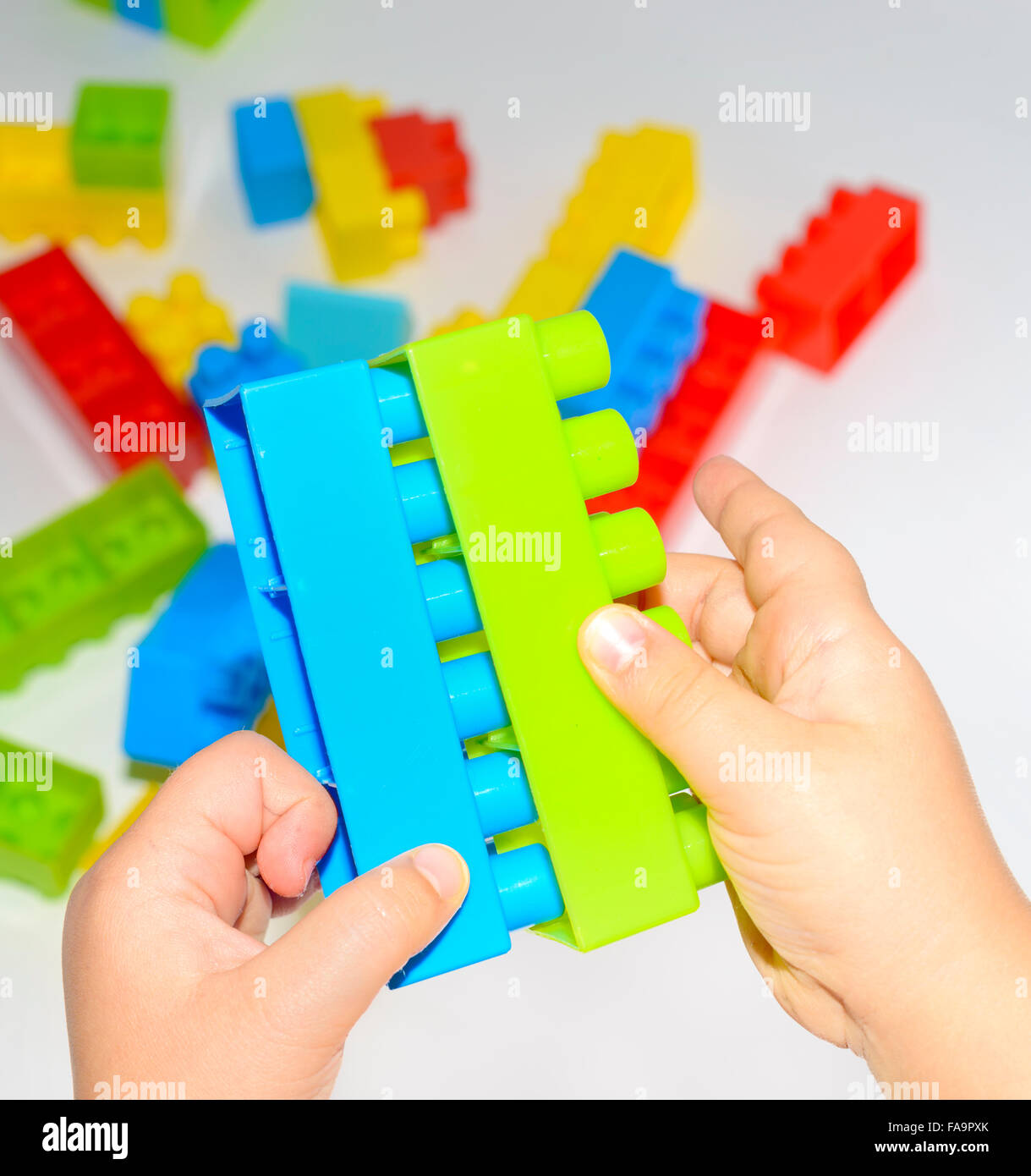 Baby girl playing with colorful blocks on white background Stock Photo ...