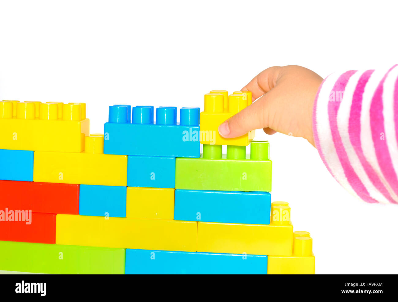 hand stack up lego set as a wall on white background Stock Photo - Alamy