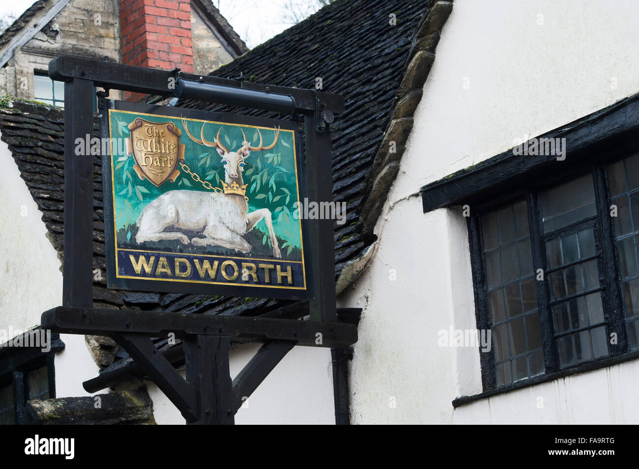 The White Hart pub sign. Castle Combe, Wiltshire, England Stock Photo ...