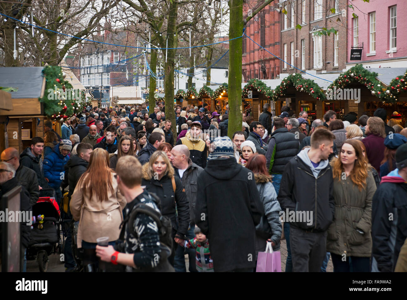 Crowds of people shopping shoppers busy at Christmas market cabins St ...
