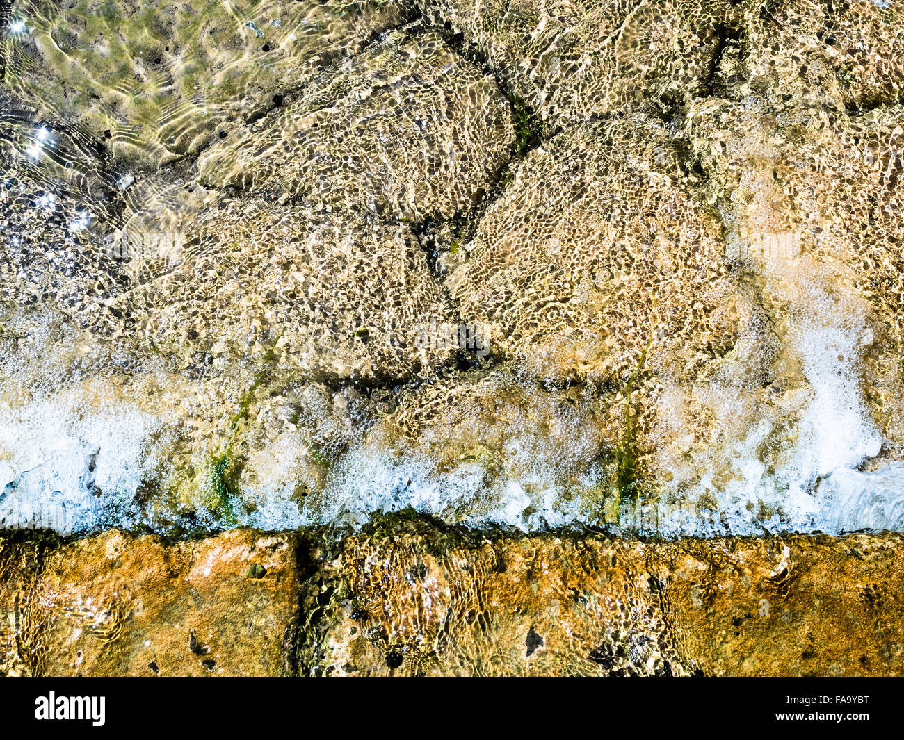 Background formed by the water of a stream flowing over rocks Stock ...