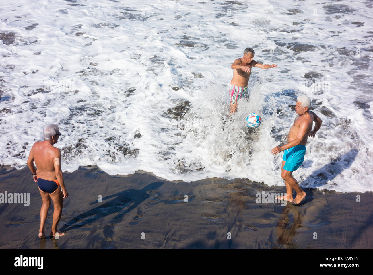 Elderly spanish men playing football on beach hi-res stock photography ...