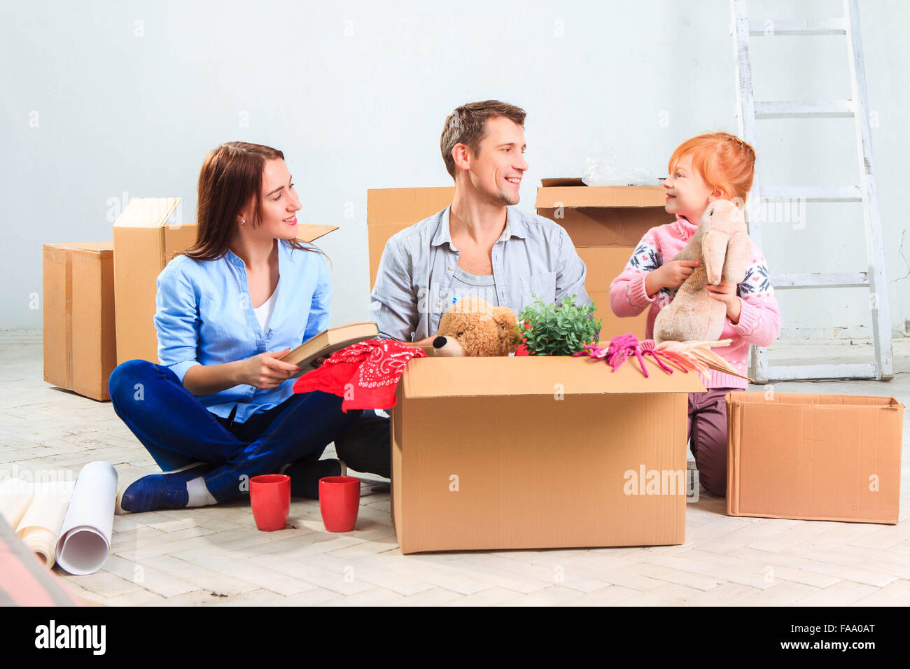 The happy family at repair and relocation Stock Photo - Alamy