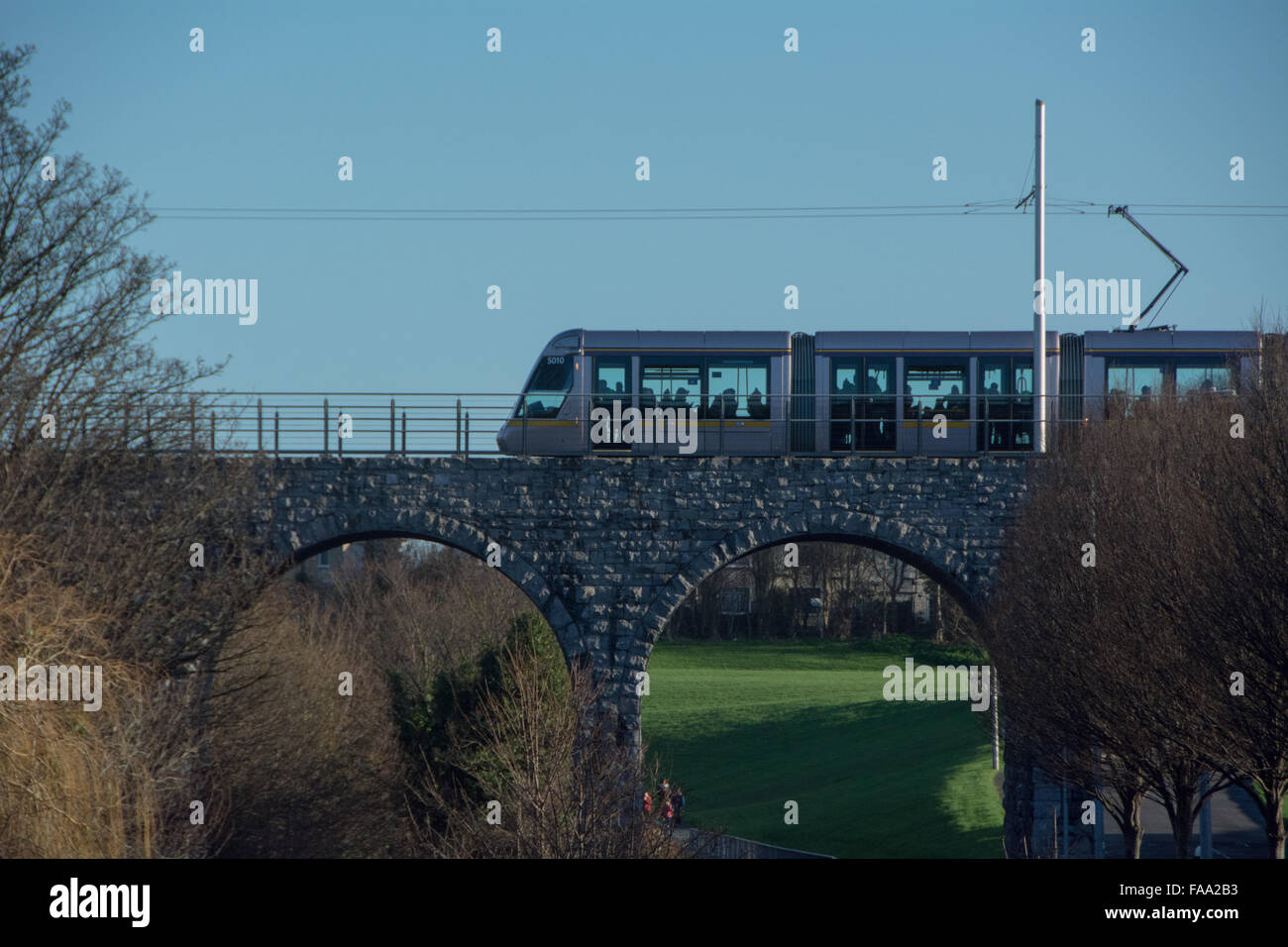 The electric LRT in Dublin called the Luas crossing a stone bridge ...