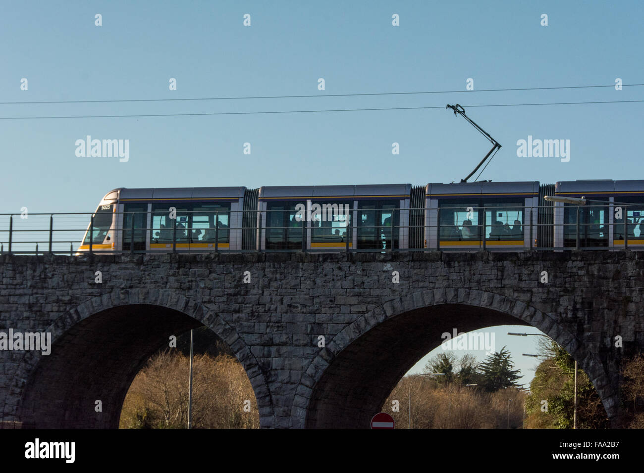 The electric LRT in Dublin called the Luas crossing a stone bridge ...