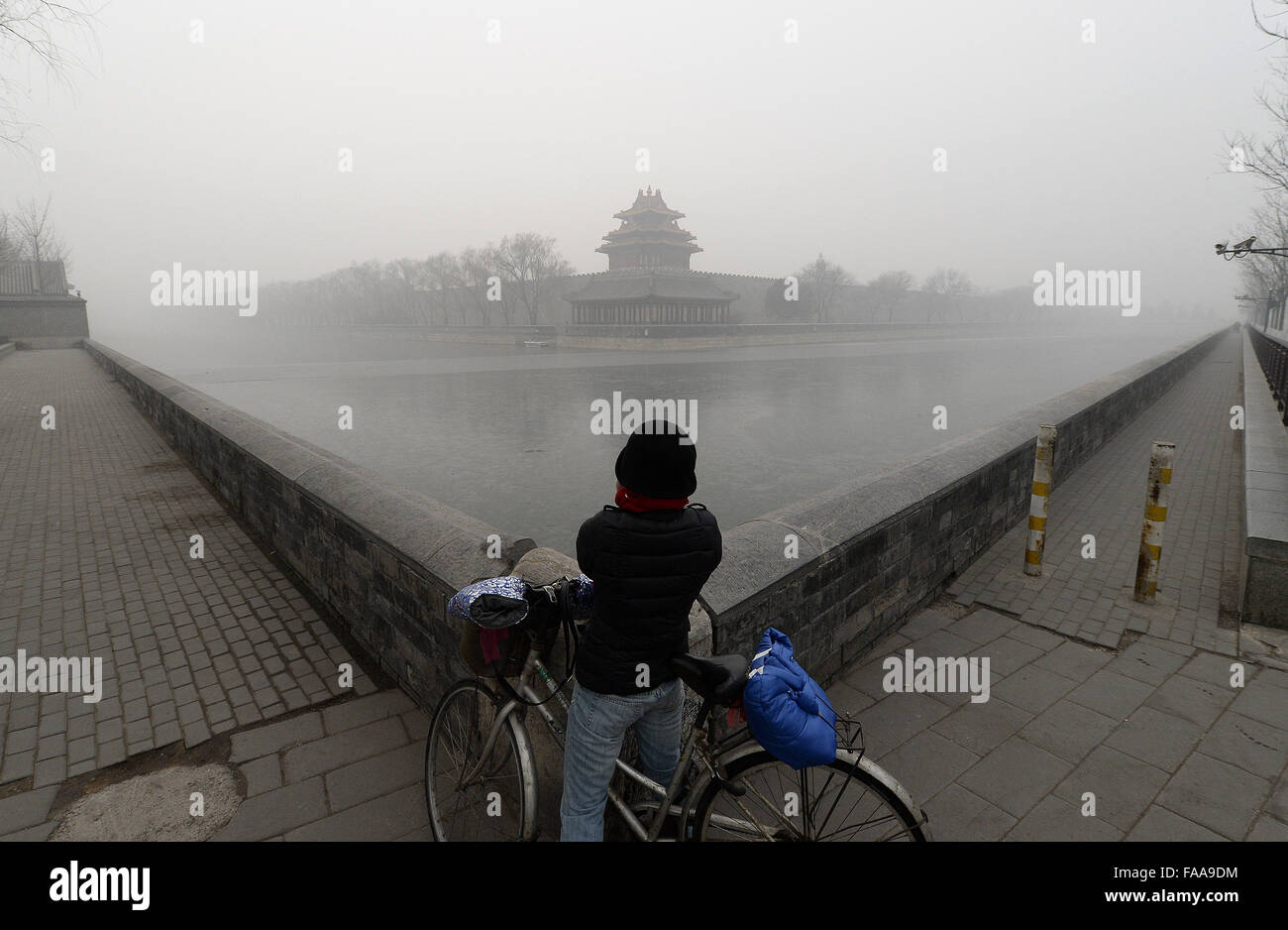 Beijing, China. 25th Dec, 2015. A cyclist takes photos of the smog ...