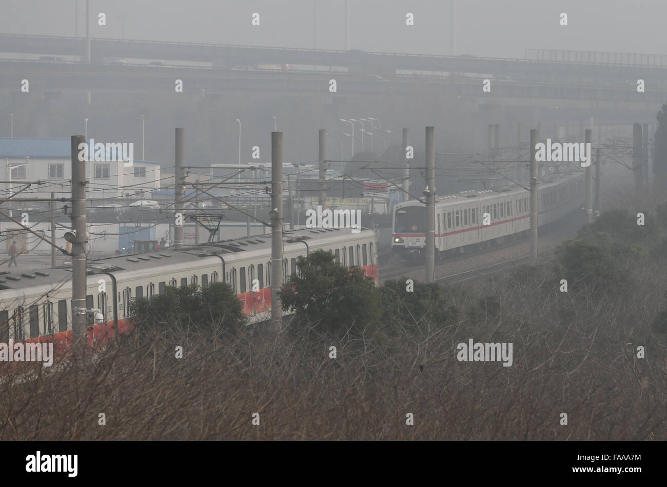 Shanghai. 25th Dec, 2015. Light rail trains run in heavy smog in east ...