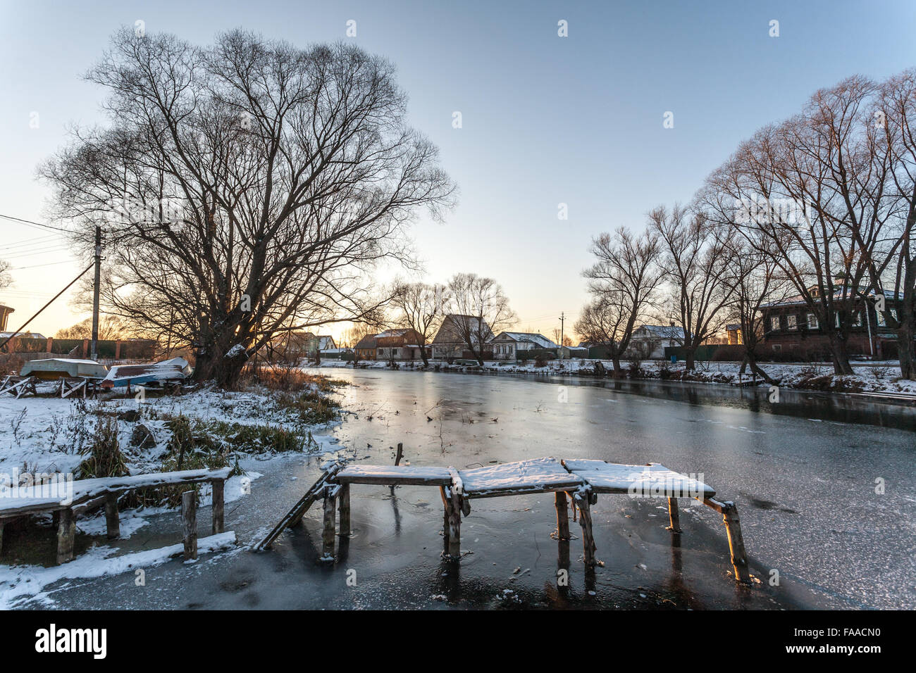 the broken bridge in snow on the freezing river Stock Photo - Alamy