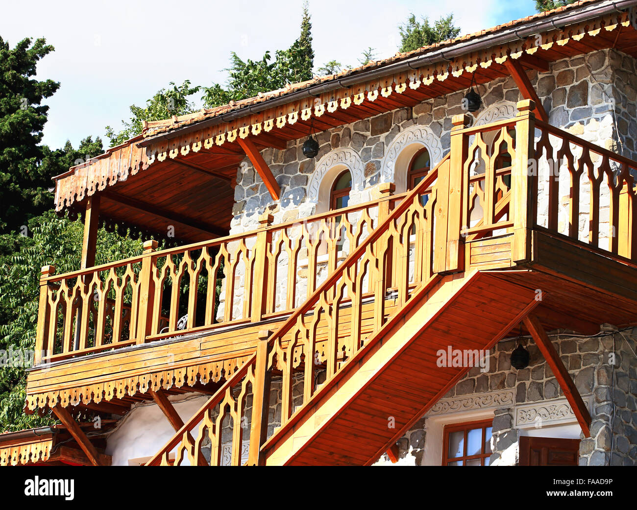Vintage wooden terrace with a ladder on the front stone house Stock ...