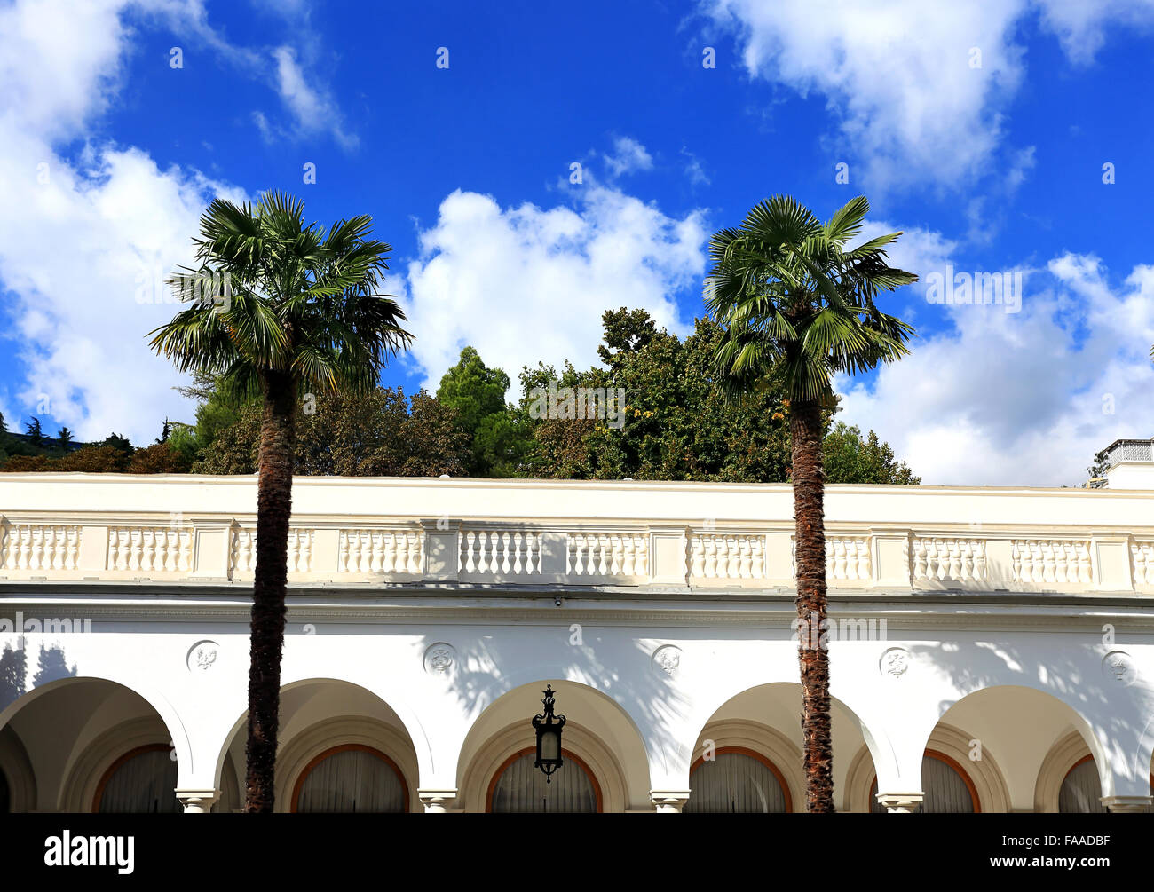Wall of the internal italian courtyard of white palace with arches and ...