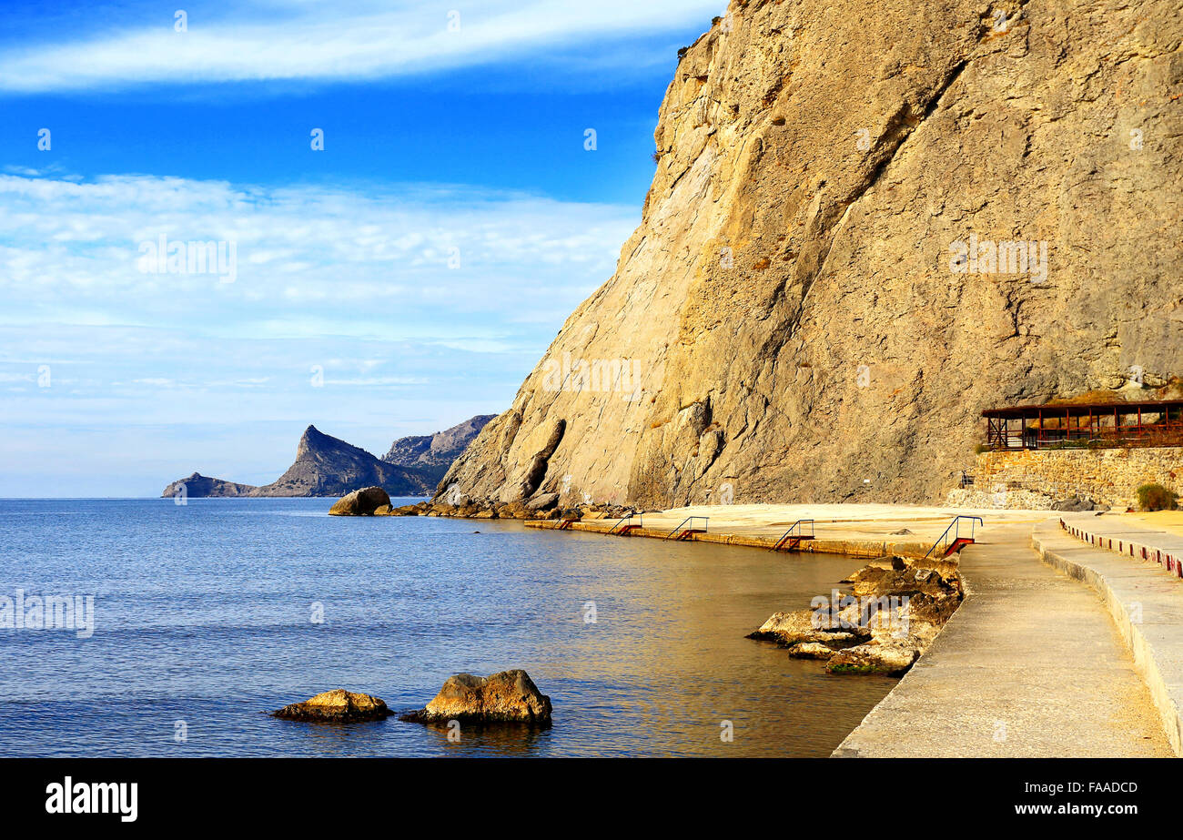 View of the sea shore with embankment, rocks and stones in water Stock ...