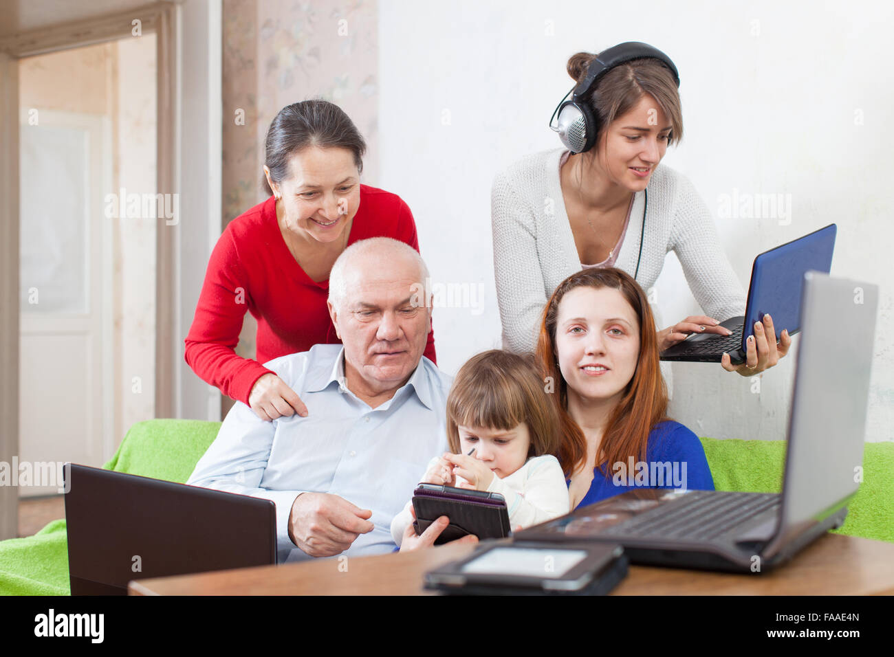 Group of people uses few various electronic devices in home Stock Photo ...