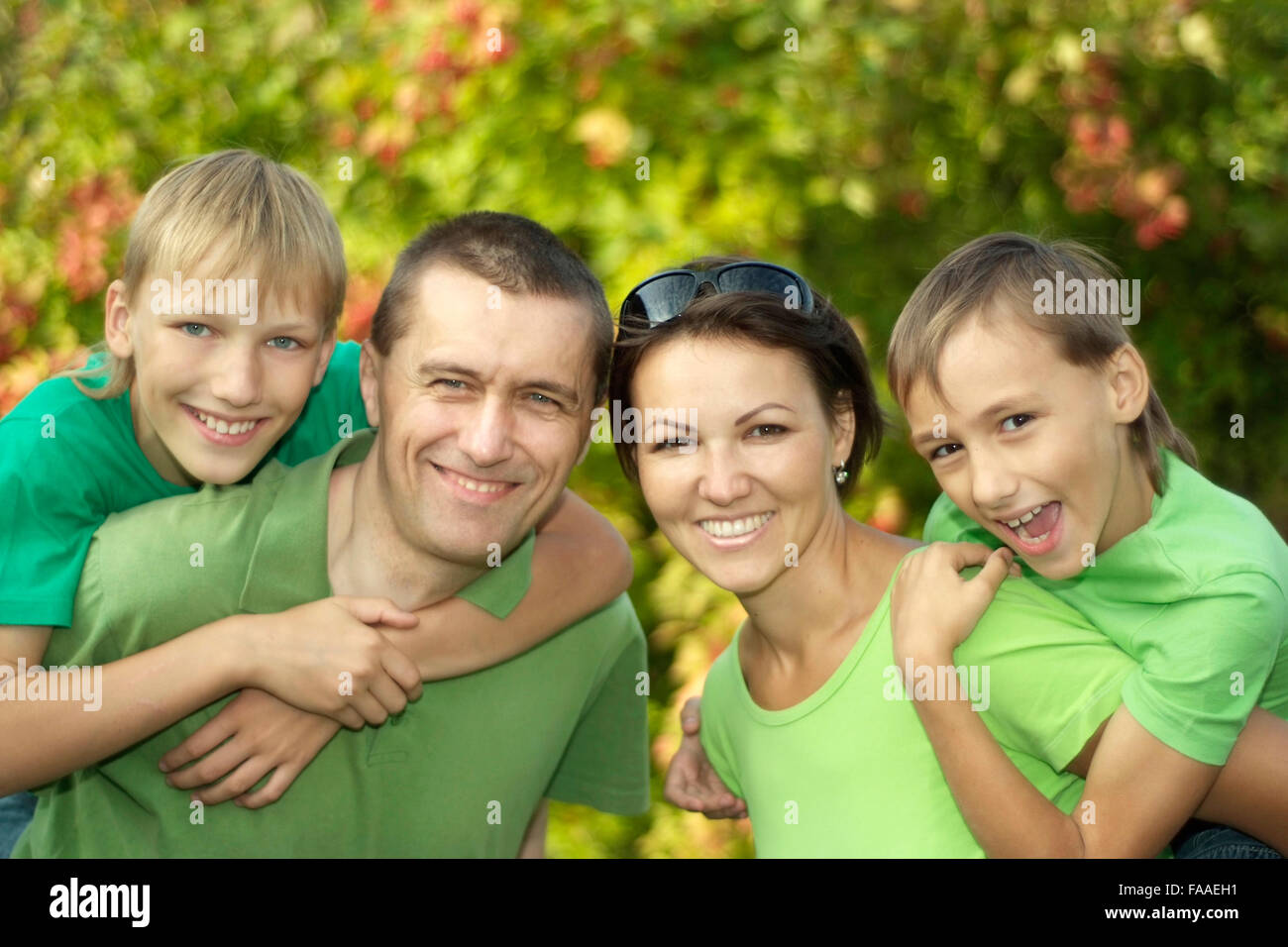 friendly family in green shirts Stock Photo - Alamy