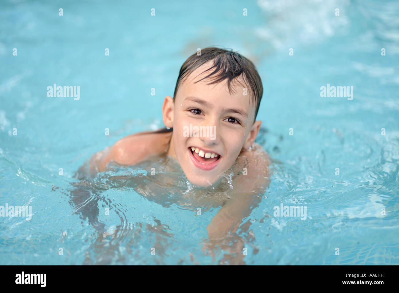 Teenage boy in pool Stock Photo - Alamy