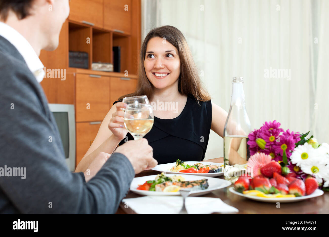 Young man and smiling cute woman having romantic dinner in home Stock ...