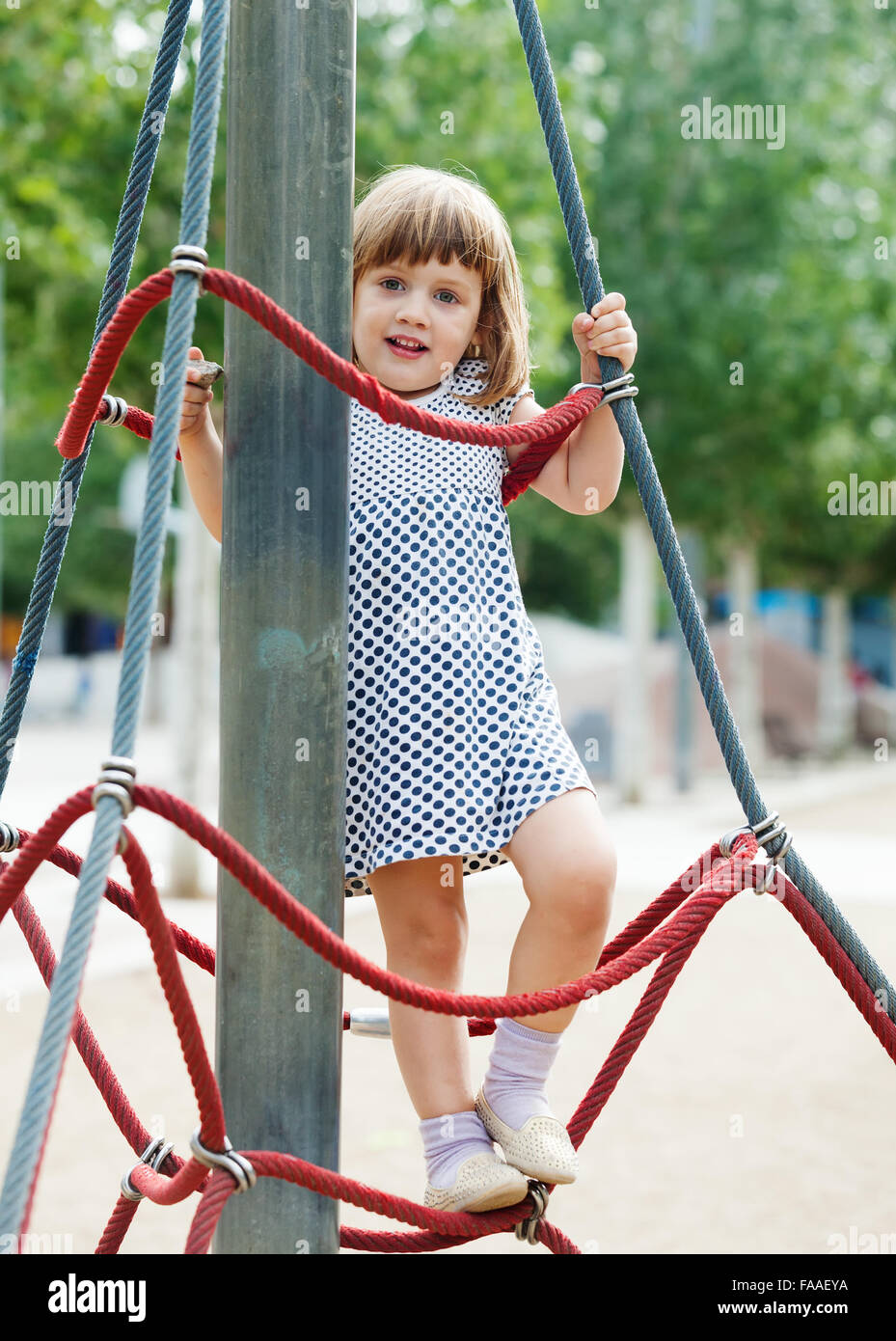child climbing at ropes on playground area in summer Stock Photo - Alamy
