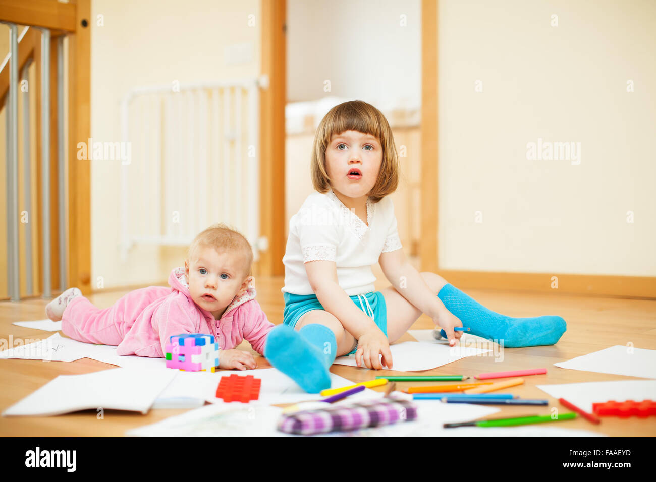 Two adorable siblings together in home interior Stock Photo - Alamy