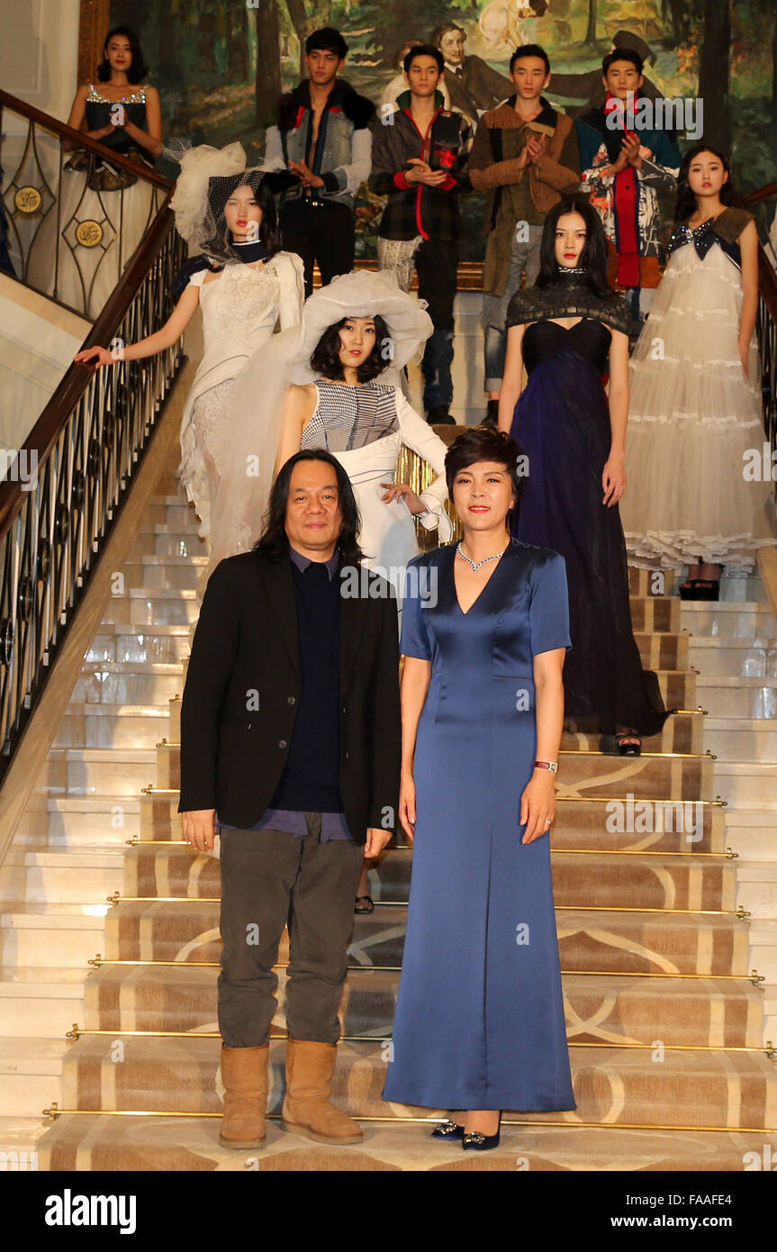 Beijing, China. 24th Dec, 2015. Chinese artist Mark Cheung (L, front) poses for a photo with ...