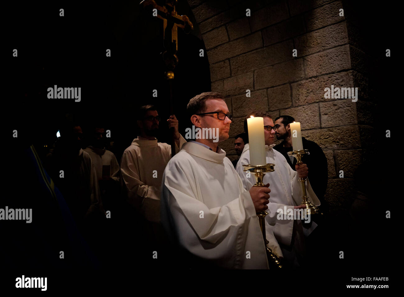 White robe monks take part in midnight Christmas mass inside the church ...