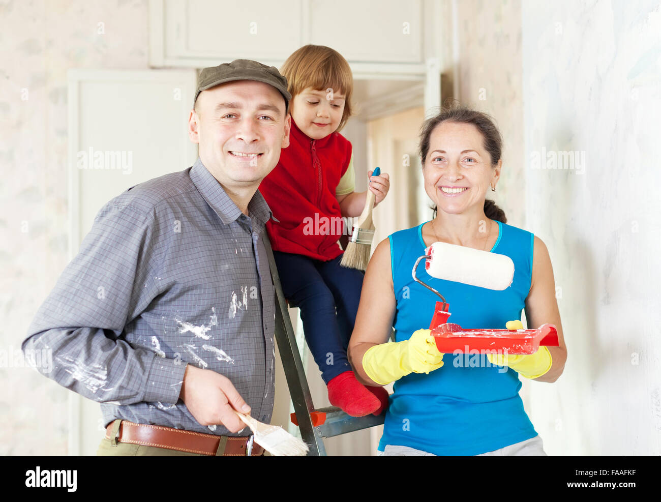 Happy family of three makes repairs at home Stock Photo - Alamy