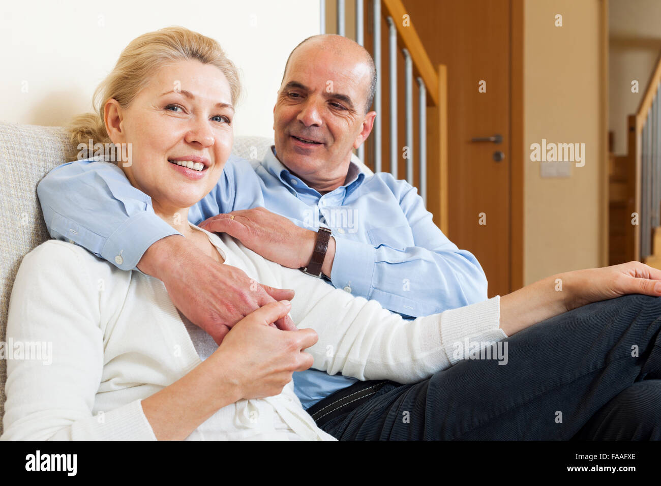 Happy senior man flirting with mature wife and hug together at home ...