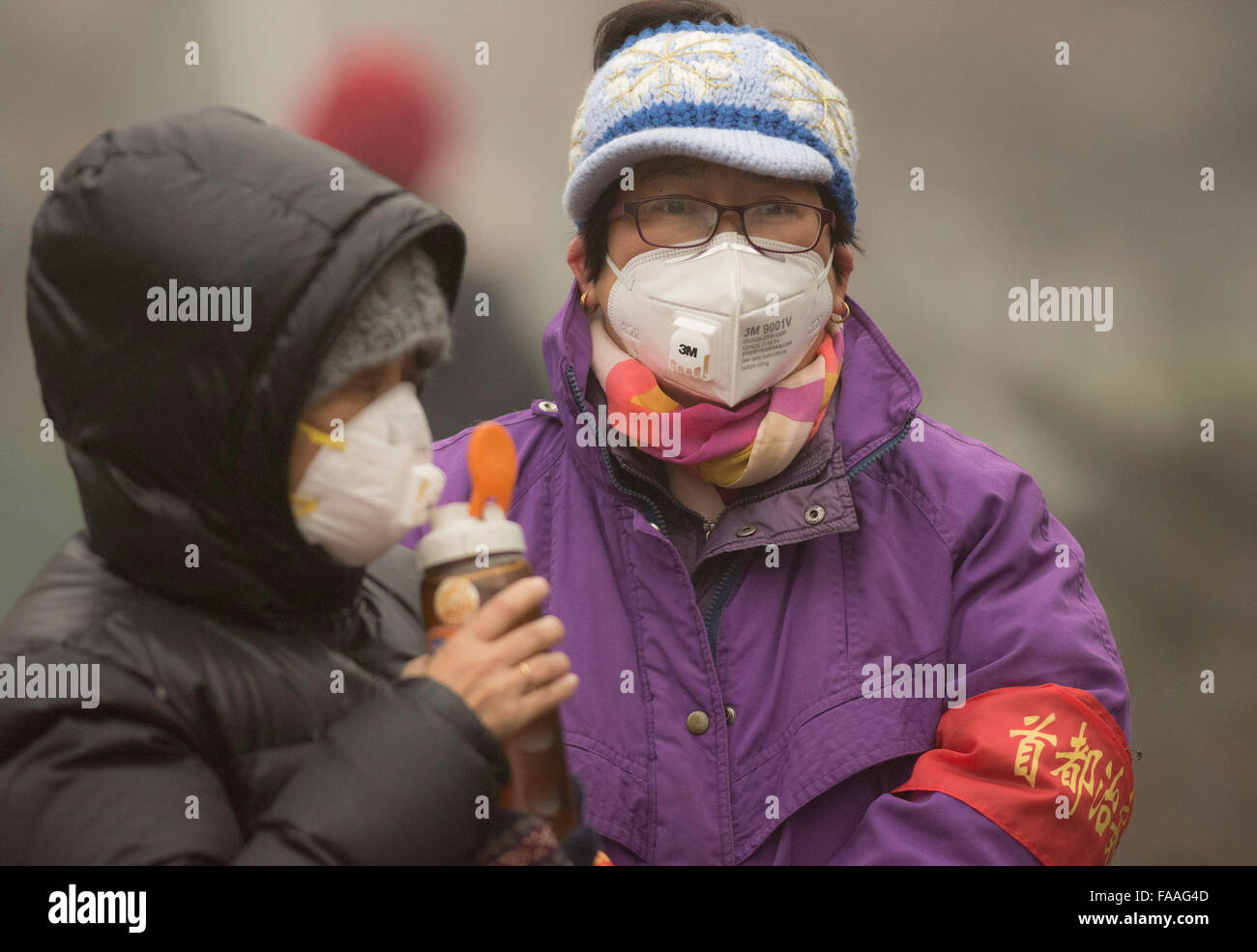 Beijing, China. 25th Dec, 2015. Public security volunteers wearing ...
