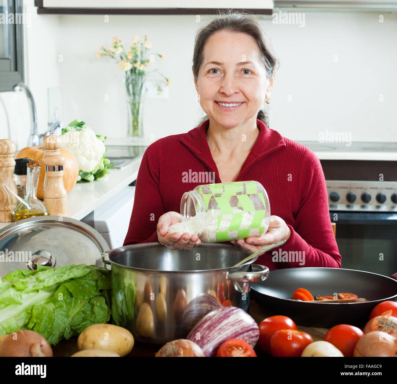 mature woman cooking with rice Stock Photo - Alamy