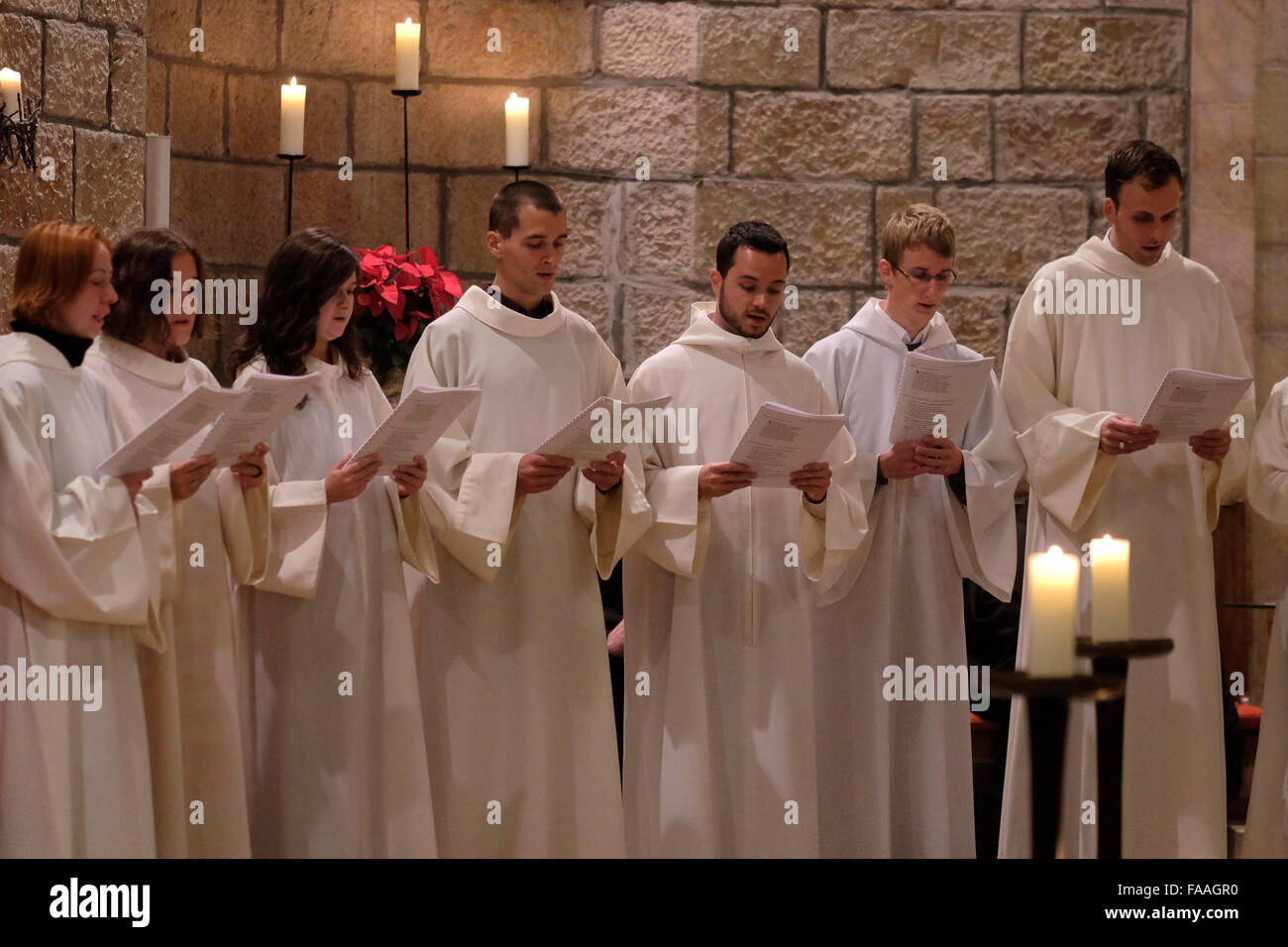 White robe monks take part in midnight Christmas mass inside the church ...