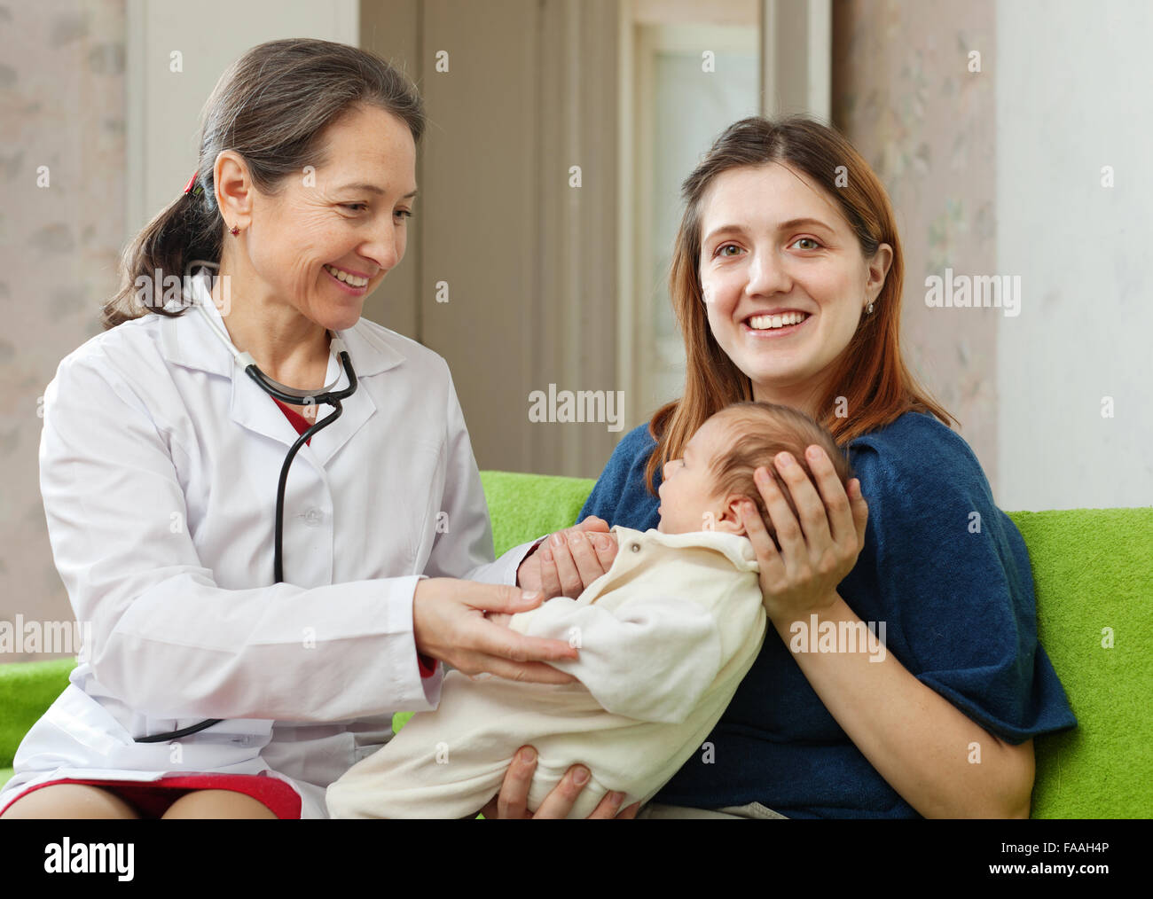 friendly mature children's doctor examining newborn baby Stock Photo ...