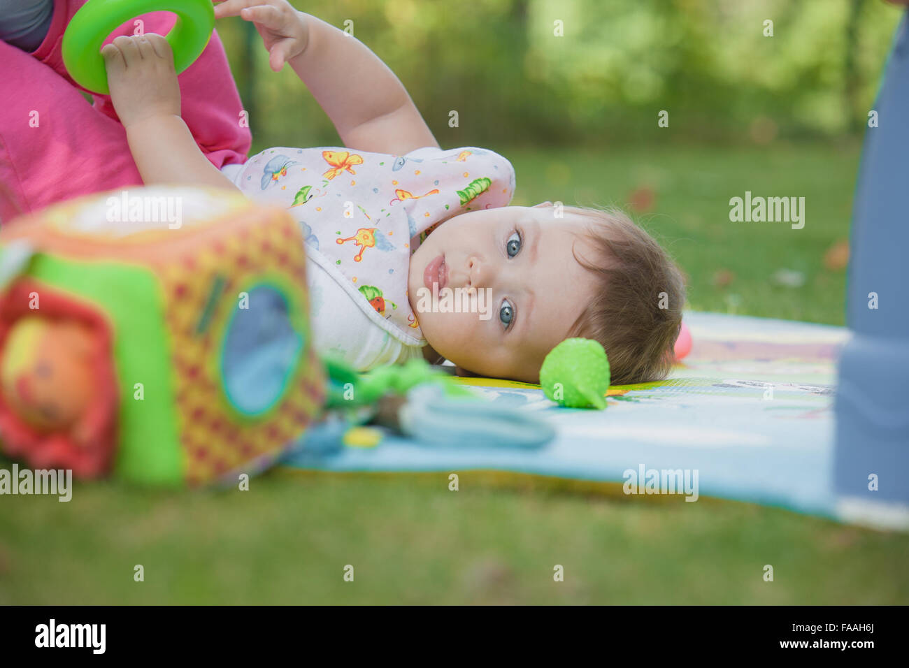 Baby, less than a year old playing with toy Stock Photo - Alamy