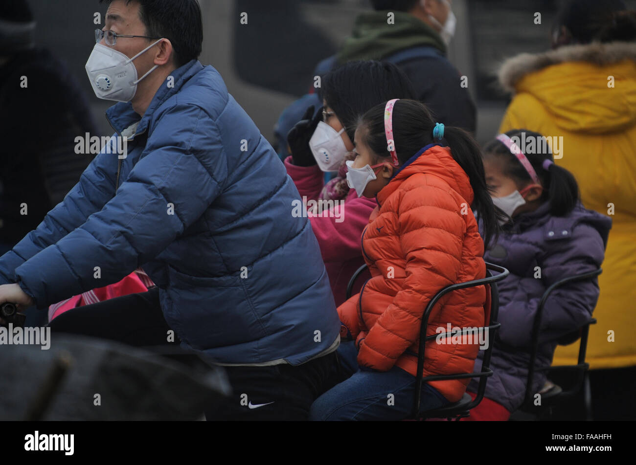 People wear masks as a thick haze of air pollution envelopes Beijing ...