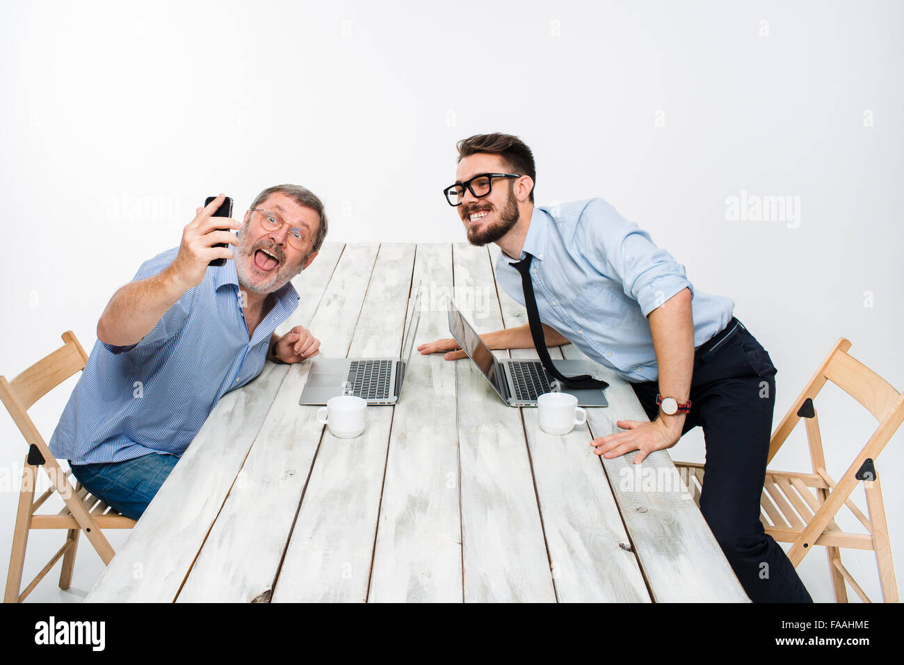 Two colleagues taking the picture to them self sitting in office Stock ...