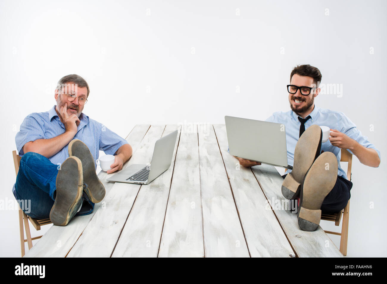 Man sitting table feet up resting hi-res stock photography and images ...
