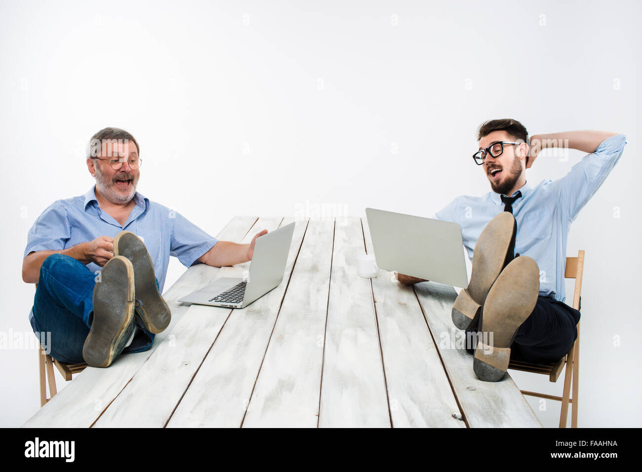 Man sitting table feet up resting hi-res stock photography and images ...