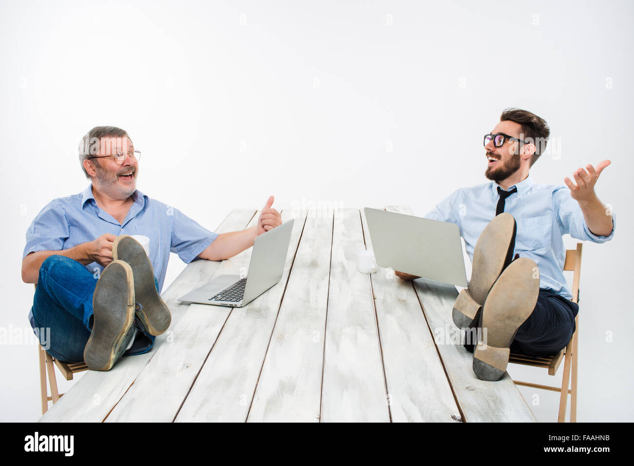 Man sitting table feet up resting hi-res stock photography and images ...
