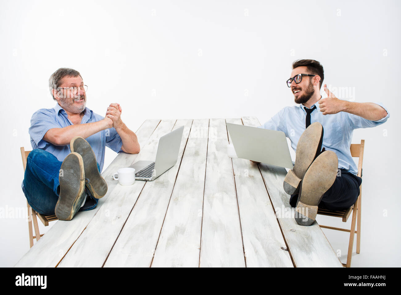 Man sitting table feet up resting hi-res stock photography and images ...