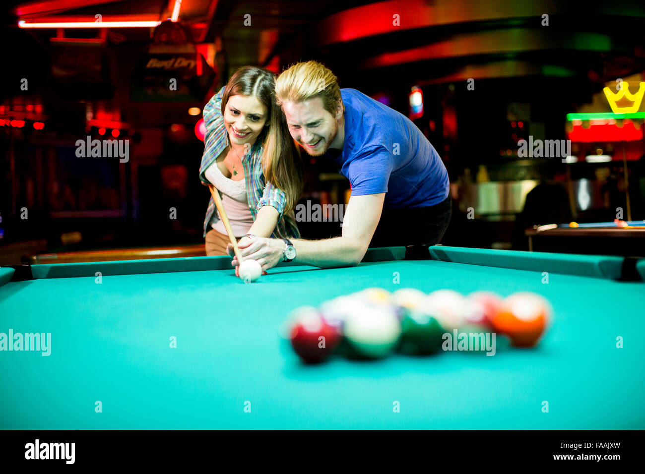 Young people playing pool Stock Photo - Alamy