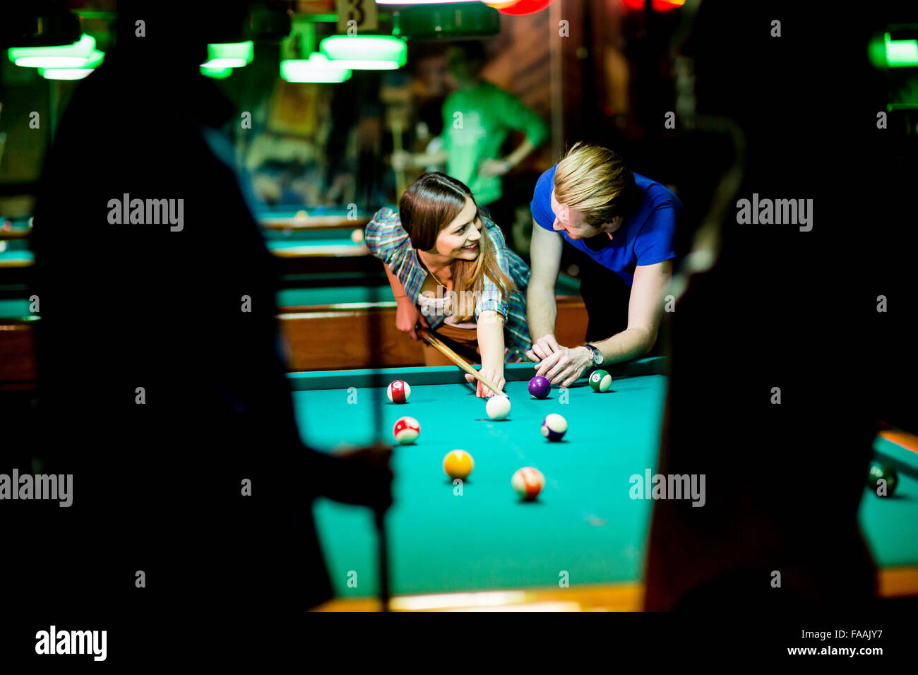 Young people playing pool Stock Photo - Alamy